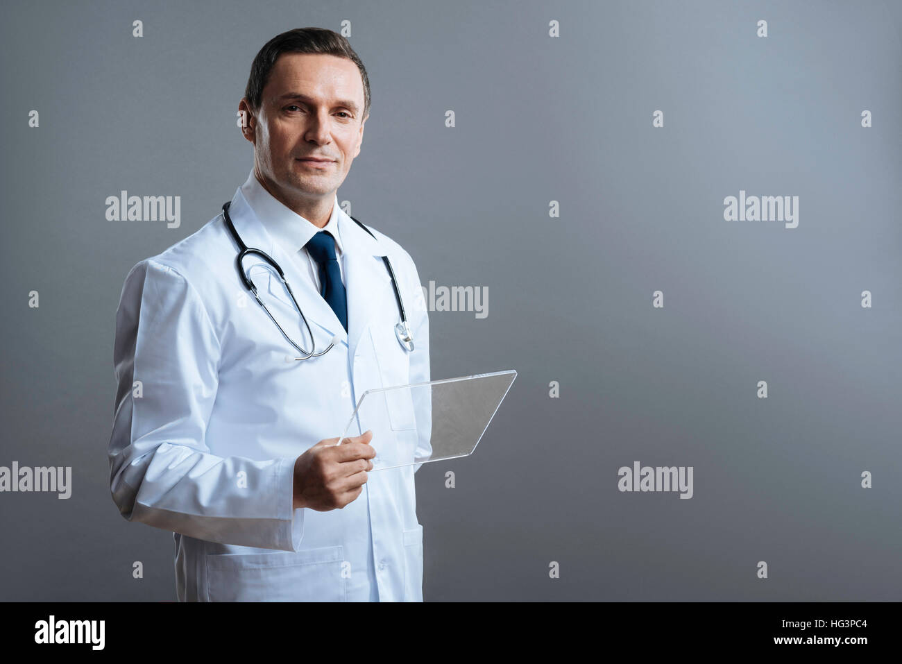 Proud doctor posing with medical glass Stock Photo - Alamy