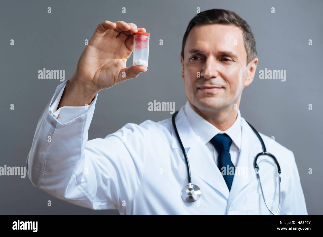 Concentrated doctor holding box with tablets Stock Photo - Alamy