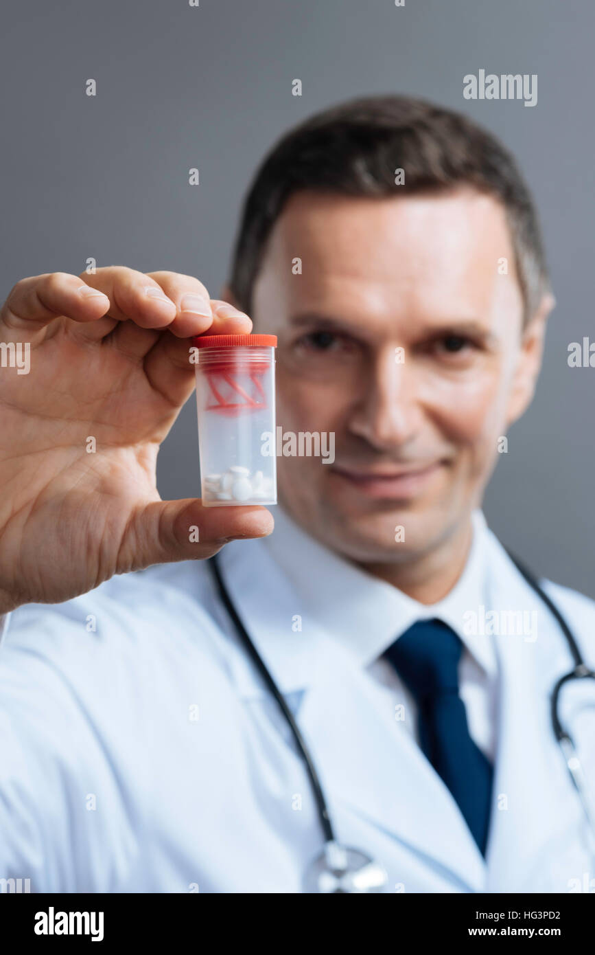 Handsome doctor holding box with medicine Stock Photo - Alamy