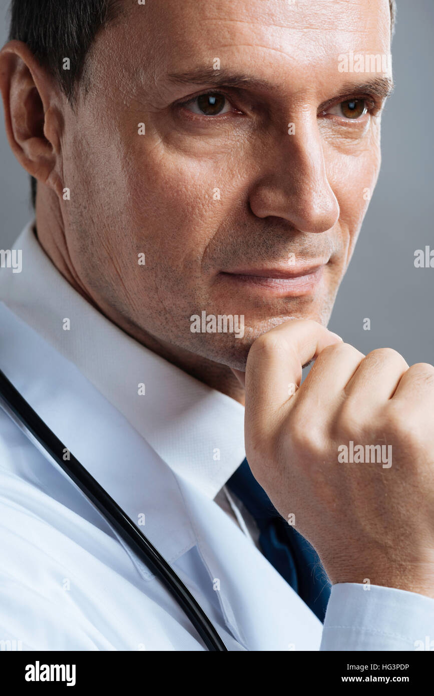 Handsome doctor making concentrated face Stock Photo - Alamy