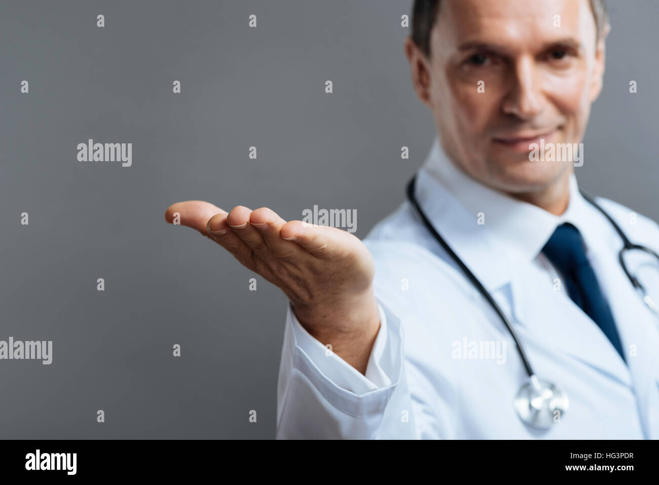 Handsome doctor making gesture with his hand Stock Photo - Alamy