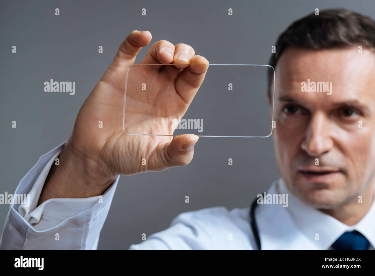 Concentrated doctor holding a glass Stock Photo - Alamy
