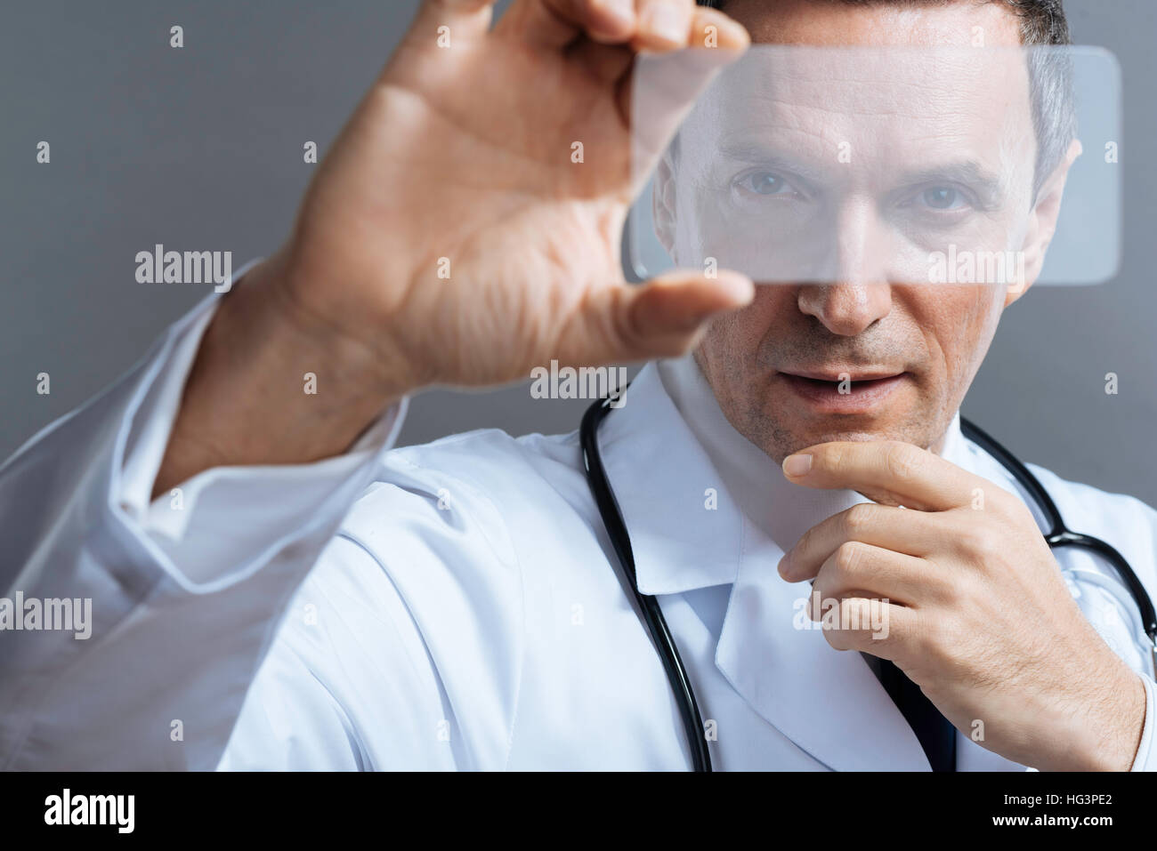 Concentrated doctor discovering something through special glass Stock ...