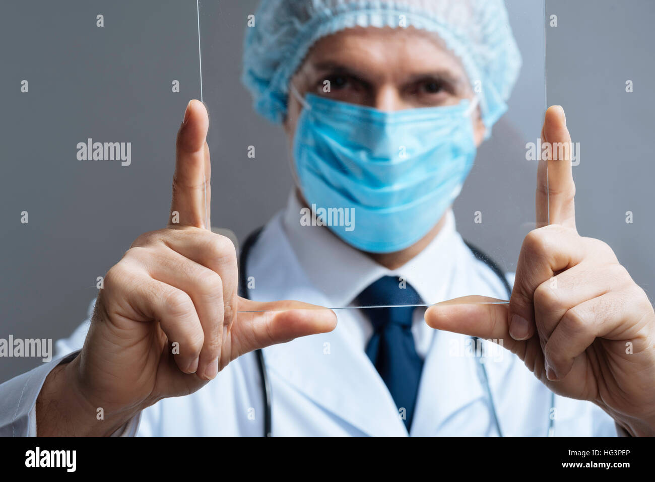 Close up of attractive doctor looking through medical glass Stock Photo ...
