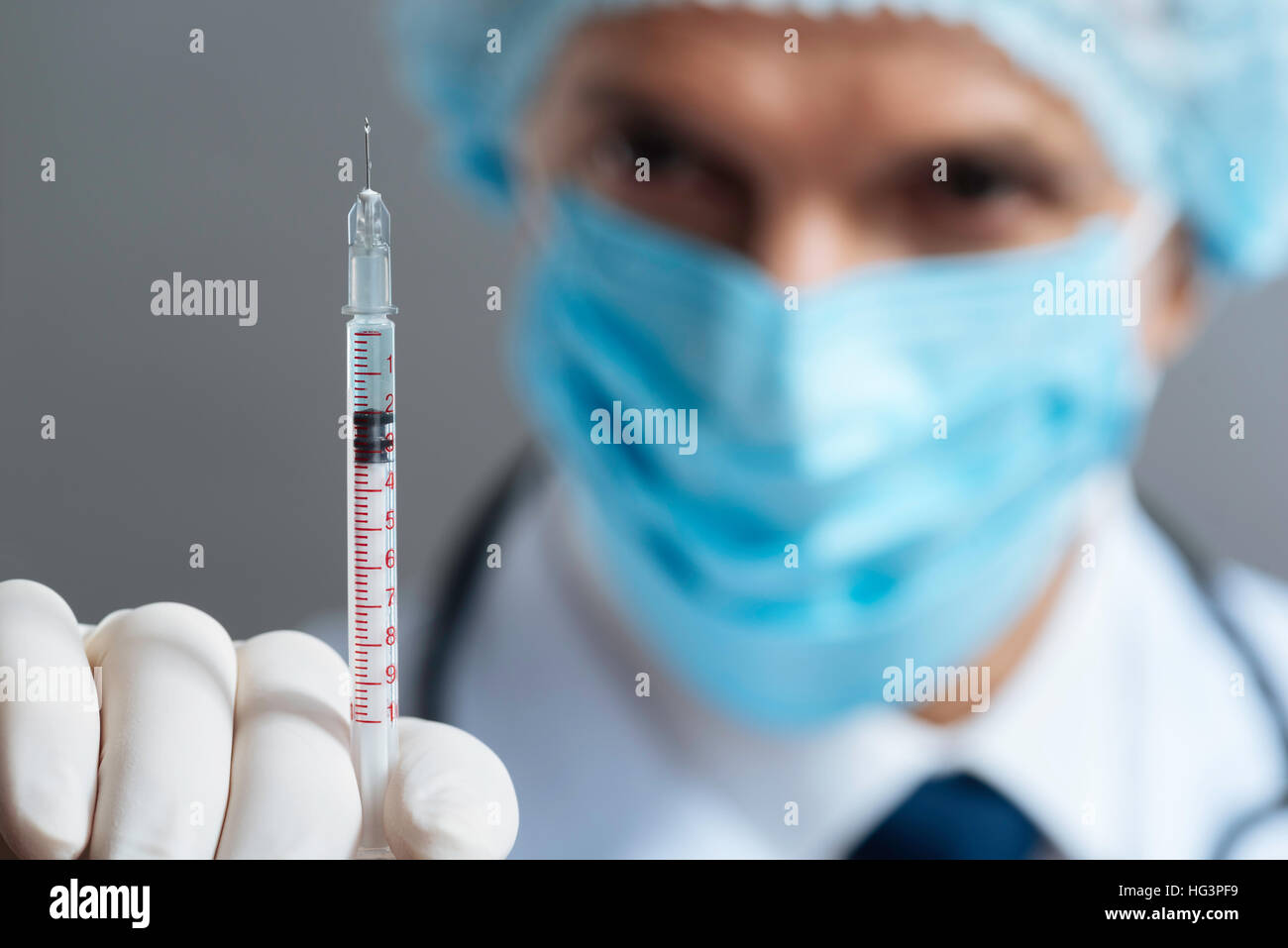 Close up of concentrated doctor holding hypodermic needle Stock Photo ...