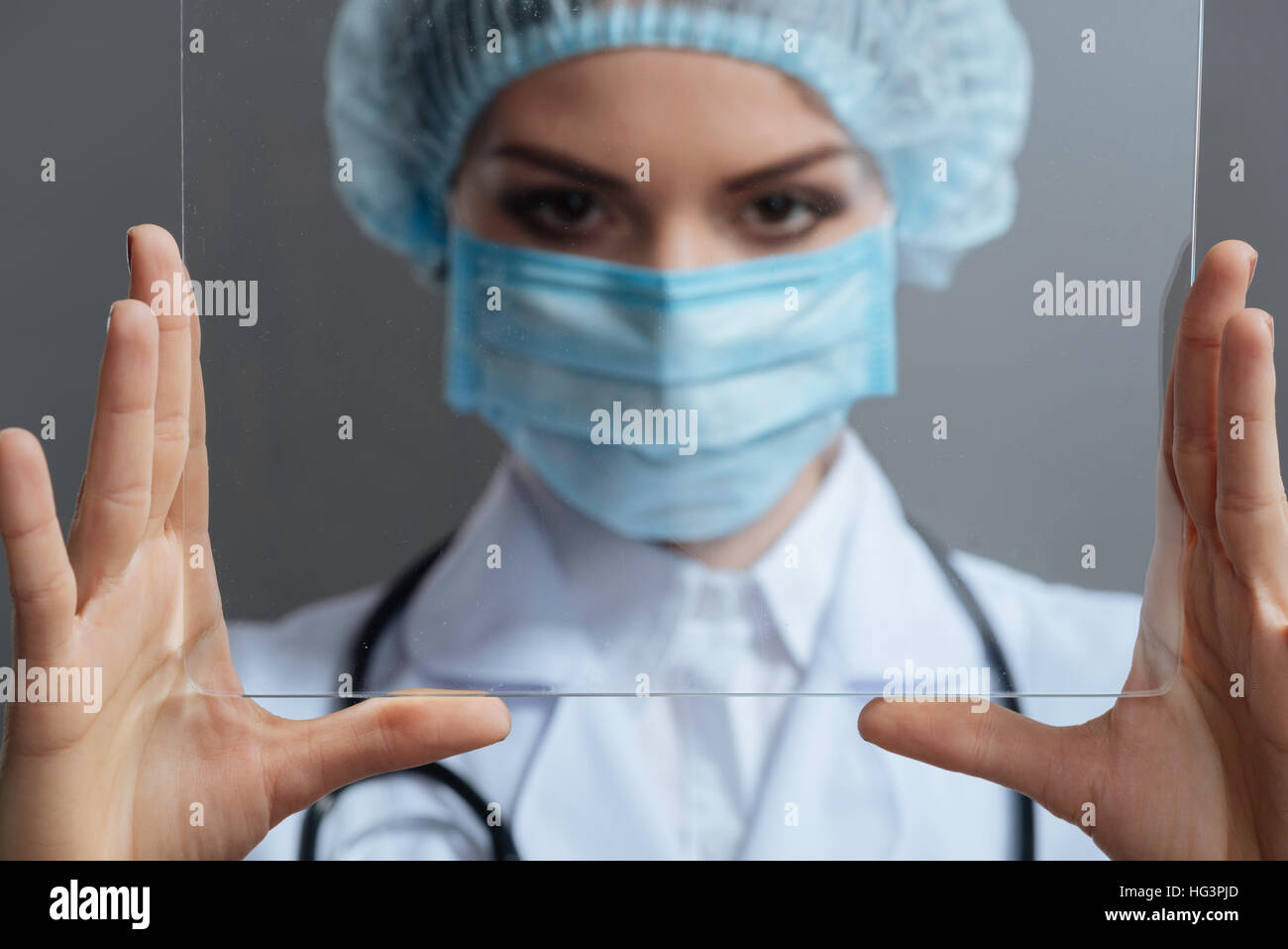 Female doctor posing with medical glass Stock Photo - Alamy
