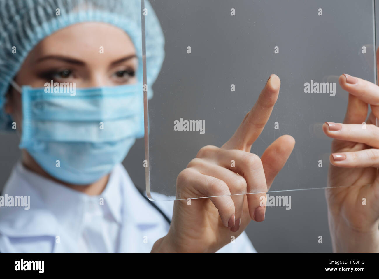 Female doctor touching medical glass Stock Photo - Alamy