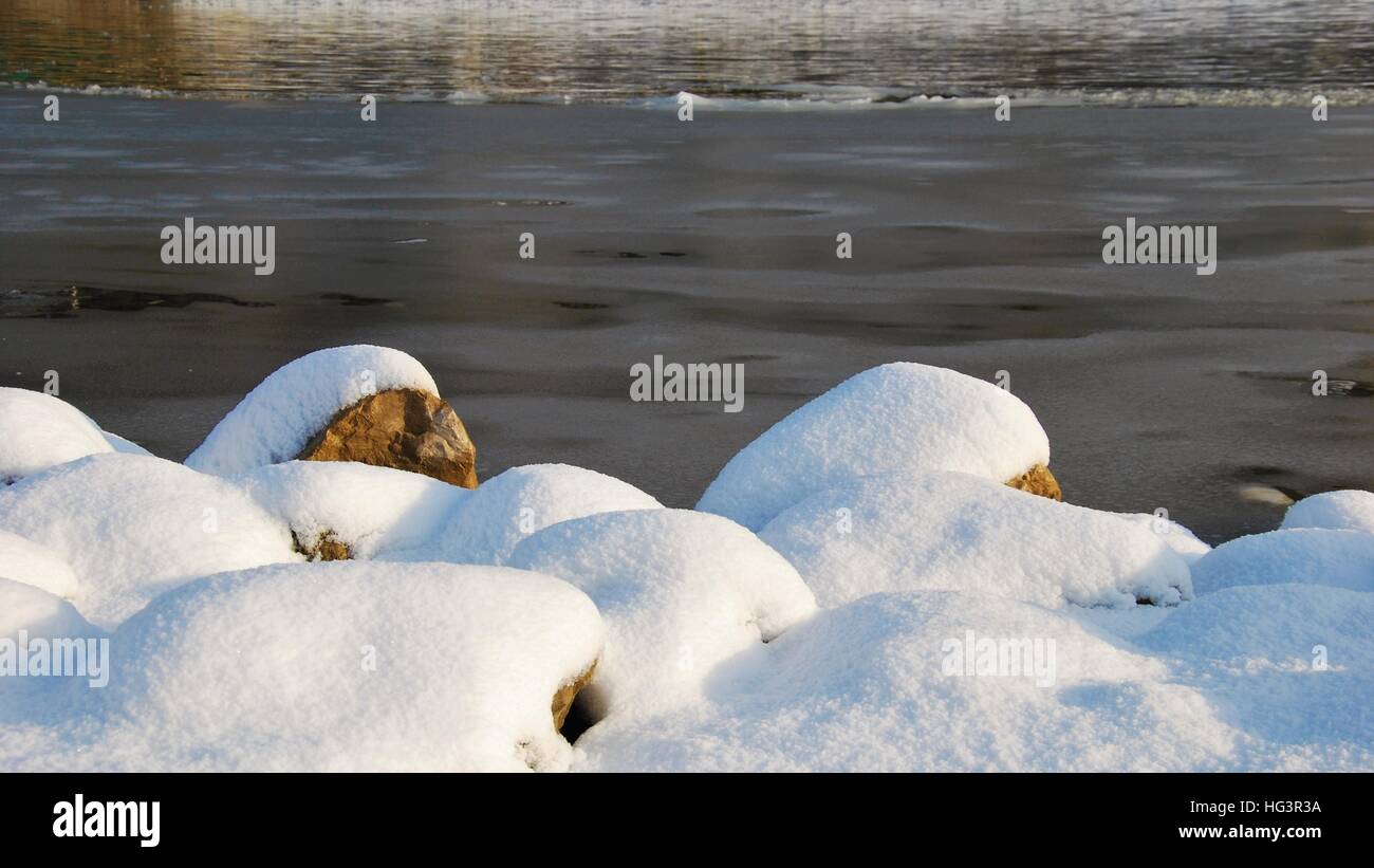 Mound of snow with frozen water in background/ waves and ice Stock ...