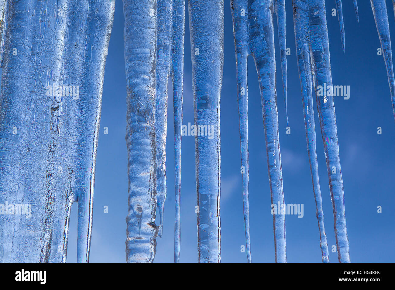 Clear icicles against blue sky Stock Photo - Alamy
