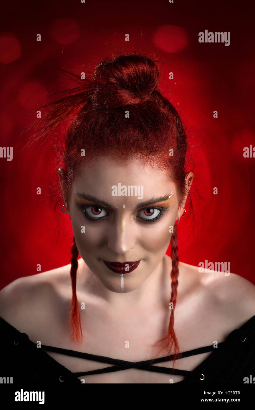 Red haired model with creative makeup in tribal style and autumnal ...