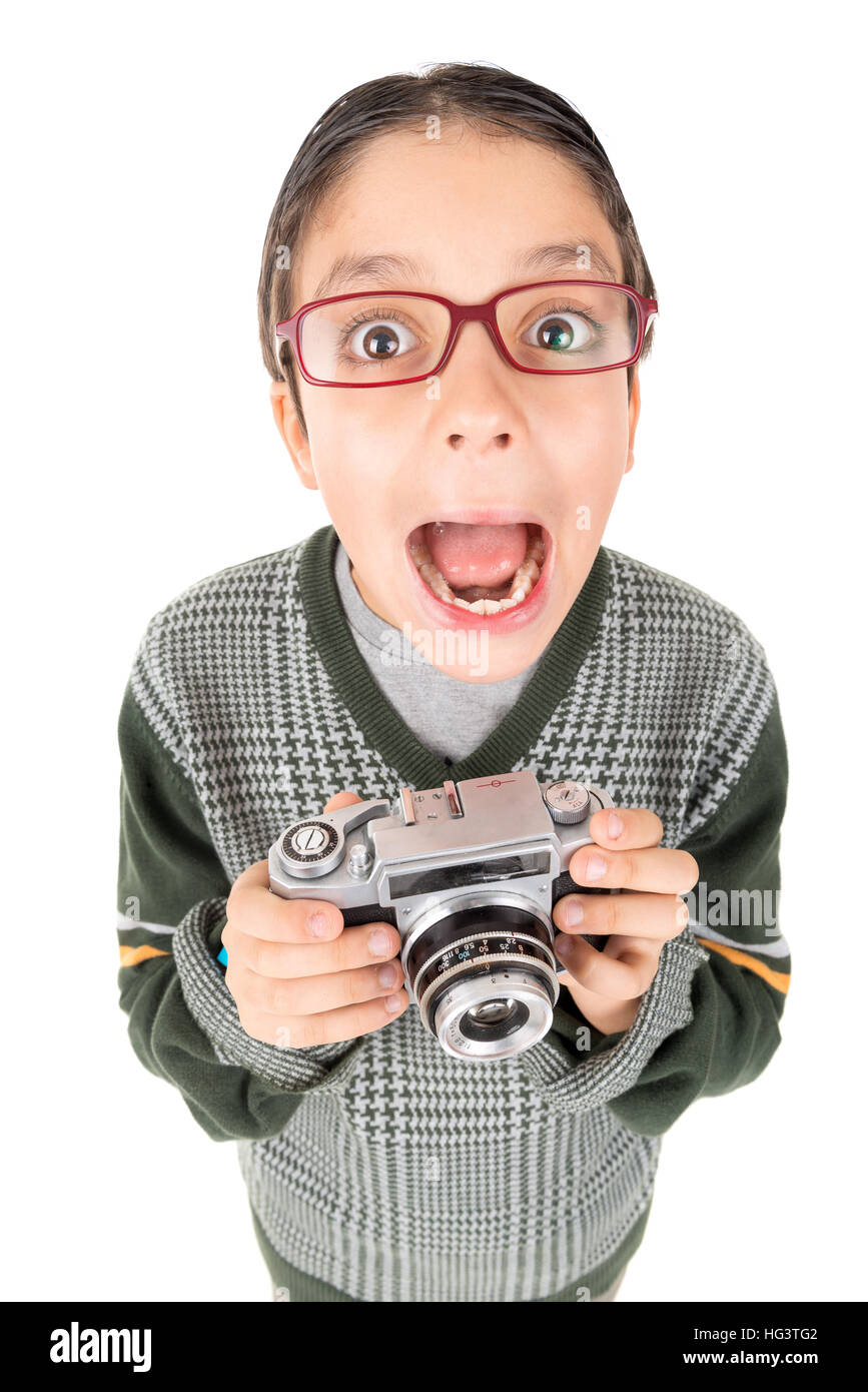 Kid with an old camera isolated in white making faces Stock Photo - Alamy