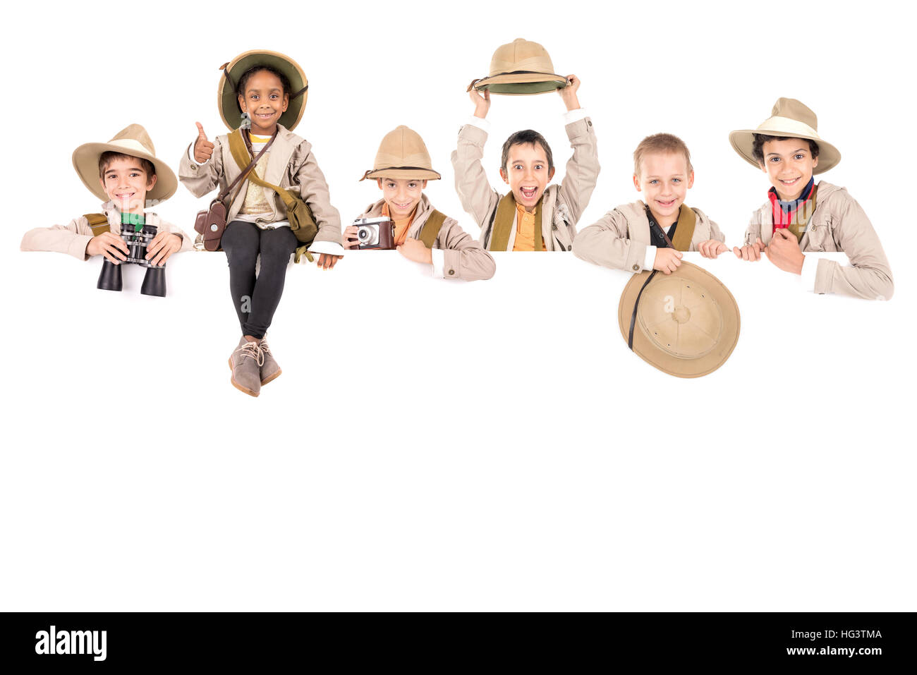 Children's group with safari clothes and gear over a white board Stock ...