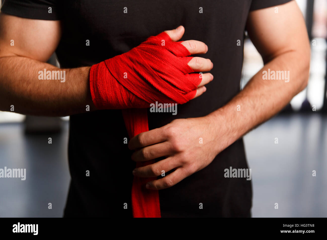 Young boxer tying red bandages Stock Photo - Alamy