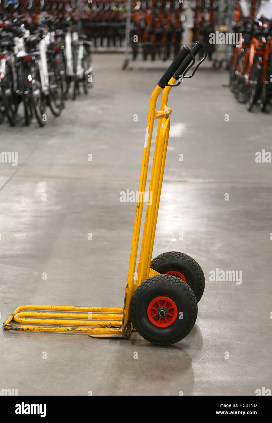 Yellow trolley for transportation of bikes in a huge warehouse Stock ...