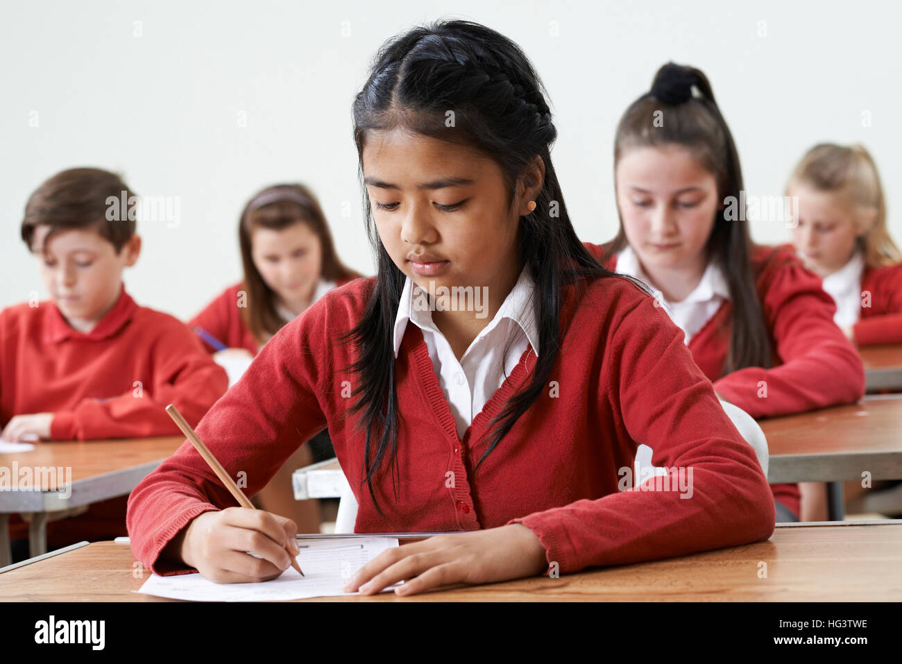 Female Pupil At Desk Taking School Exam Stock Photo - Alamy
