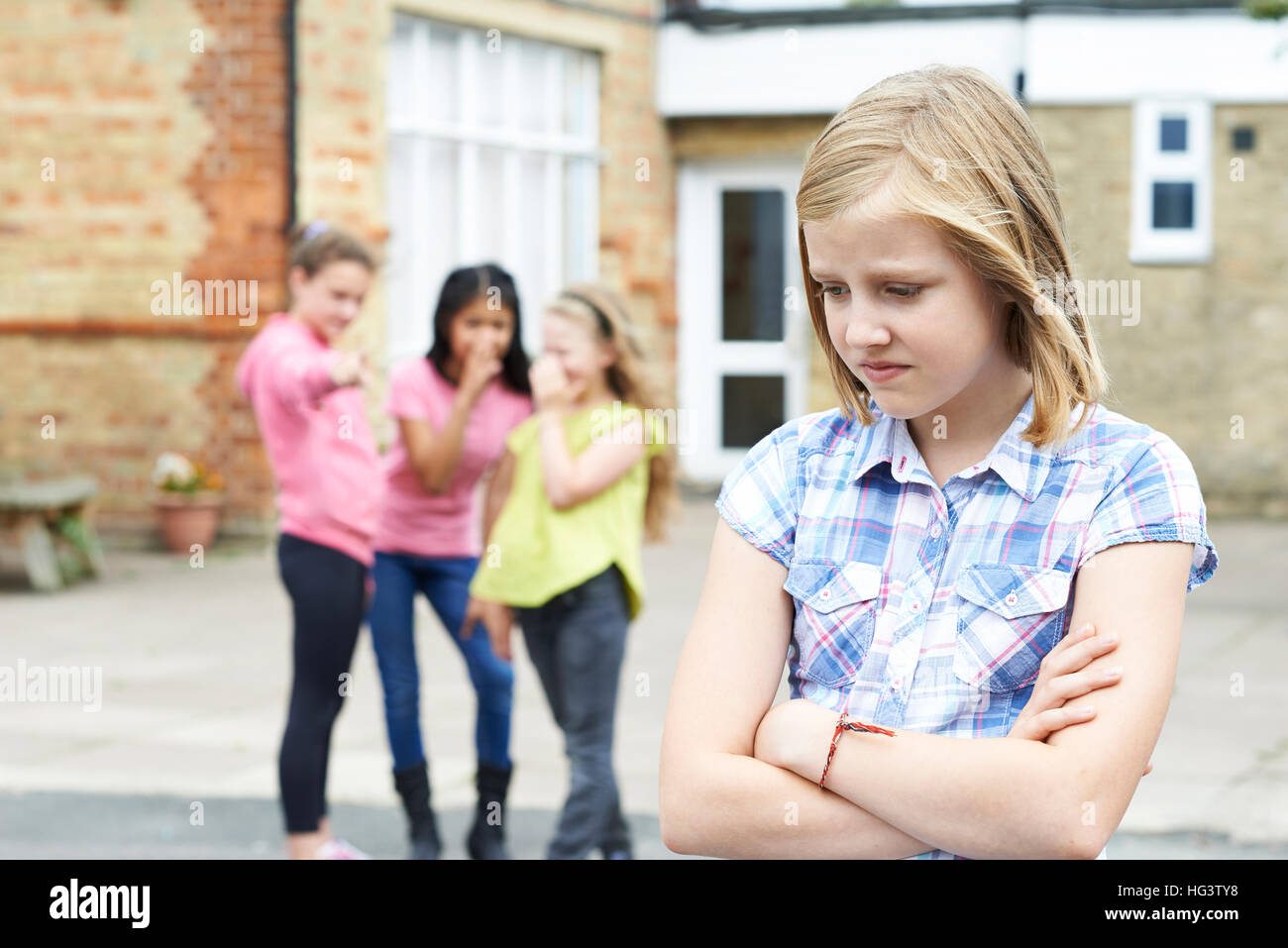 Unhappy Girl Being Gossiped About By School Friends Stock Photo - Alamy