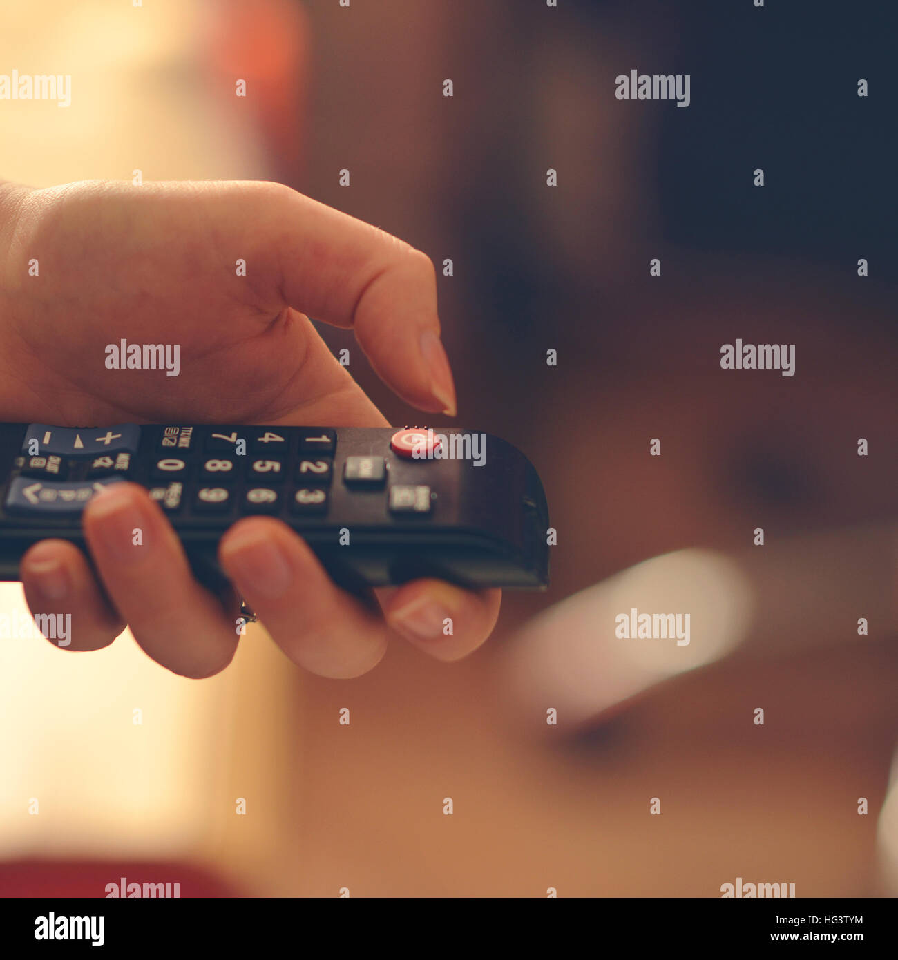 Woman hands holding remote controller Stock Photo - Alamy