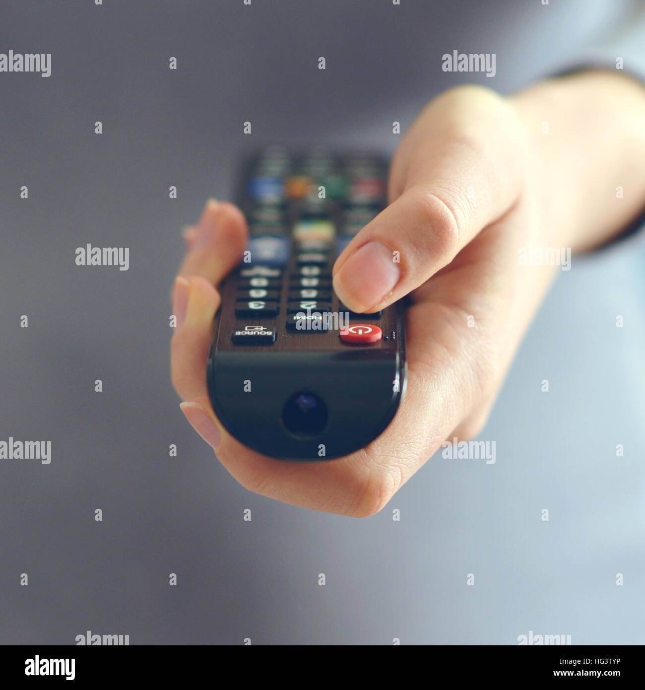 Woman hands holding remote controller Stock Photo - Alamy