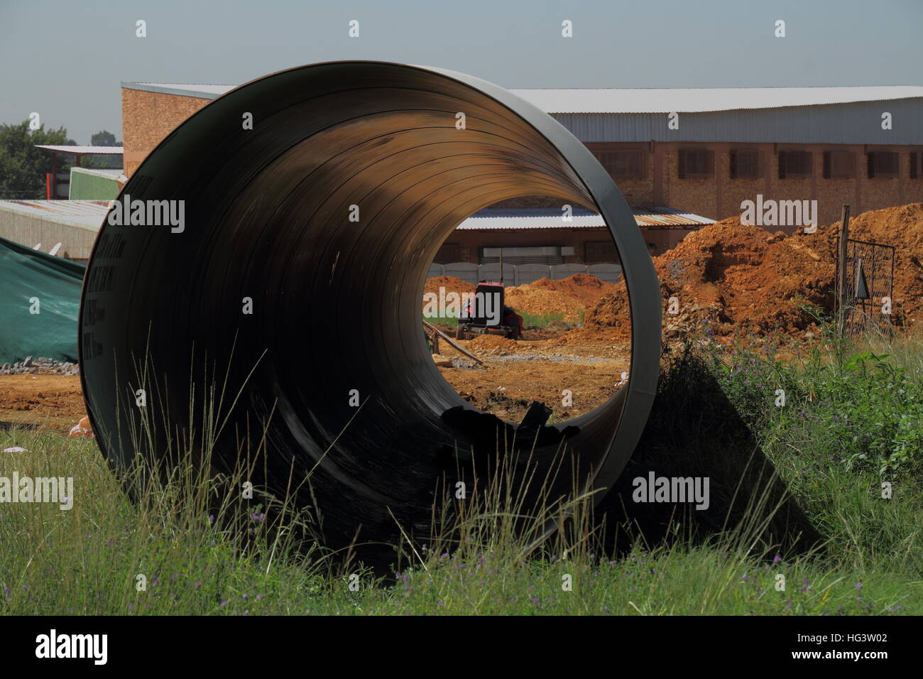 View of a civil construction site through the inside of a large metal ...