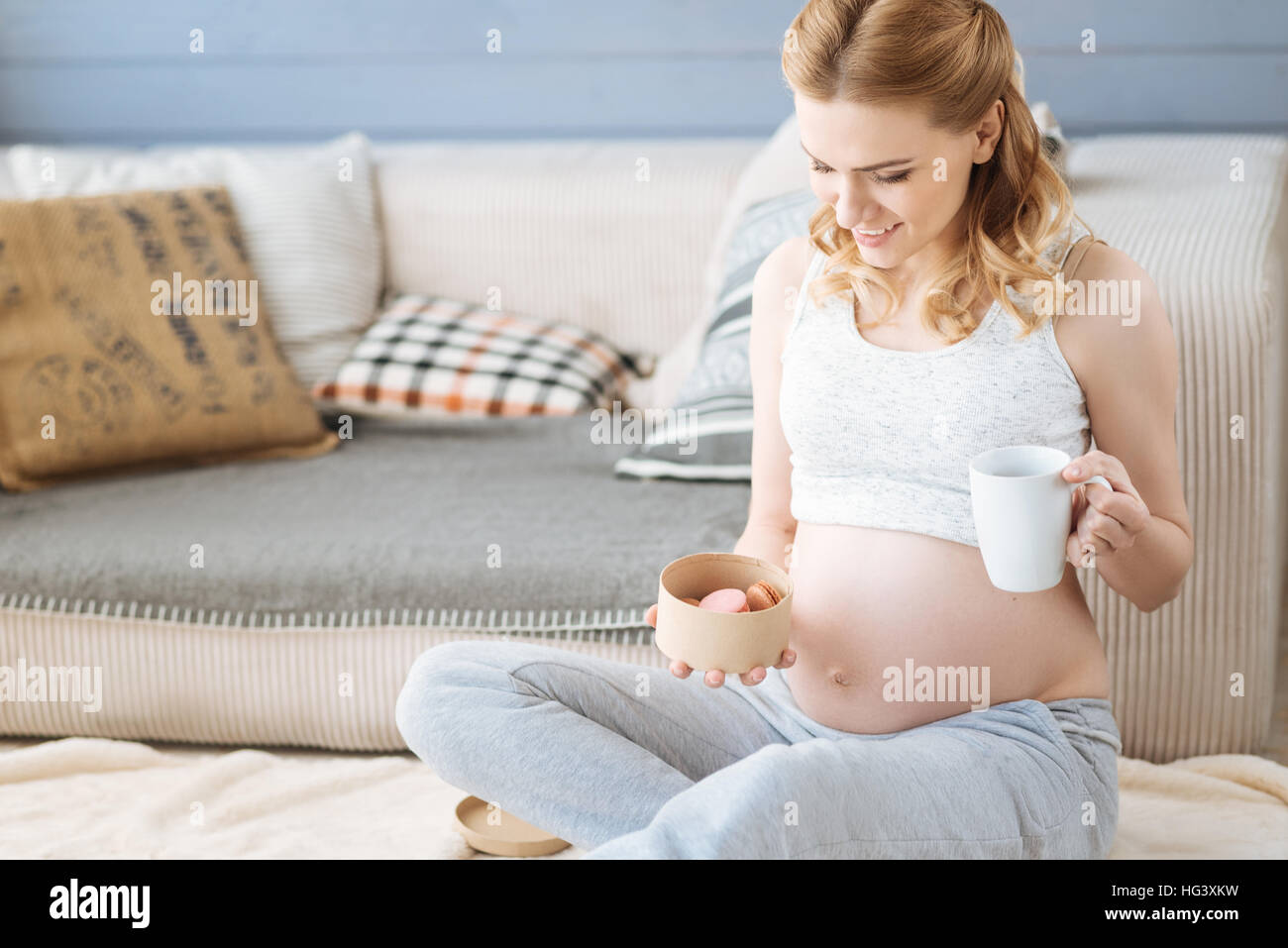Pregnant woman drinking tea with macaroons Stock Photo - Alamy