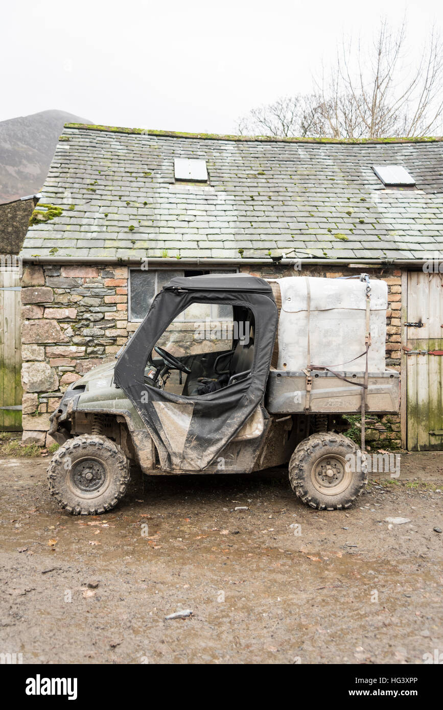 A muddy polaris ranger all terrain off road farm vehicle or quad on a ...
