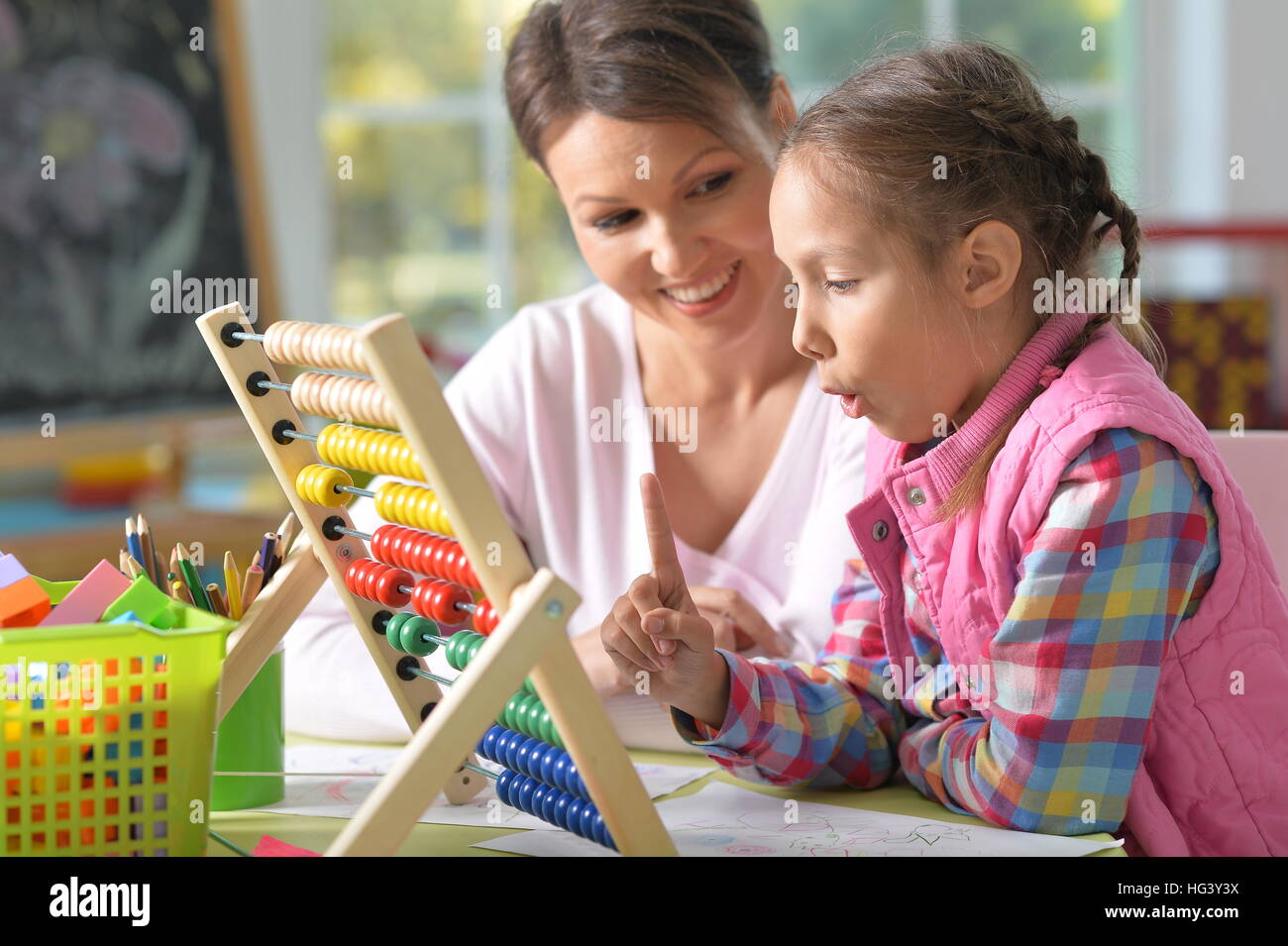 Mother and daughter do homework Stock Photo - Alamy