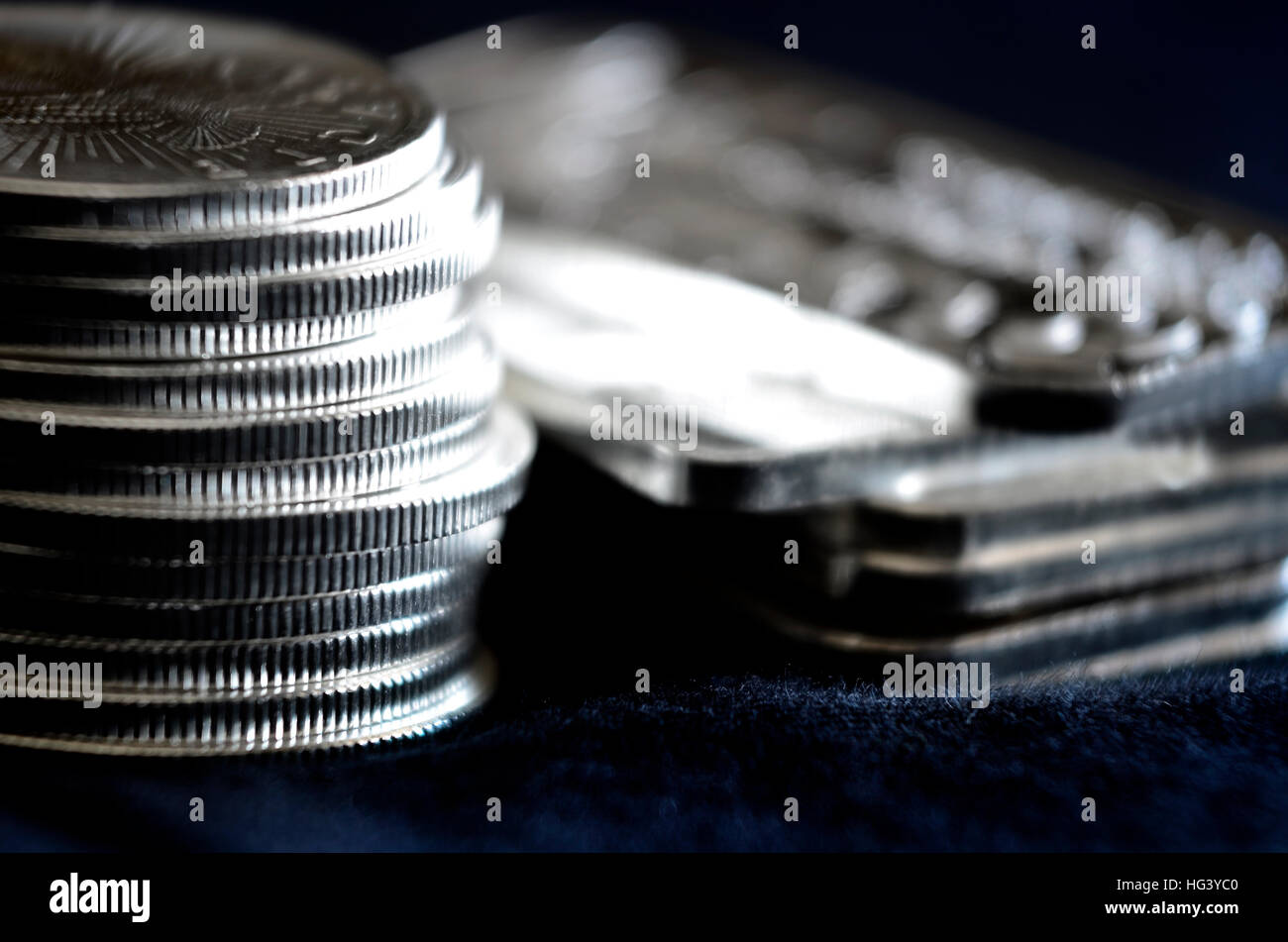 Wealth represented by silver coins and bars money Stock Photo - Alamy