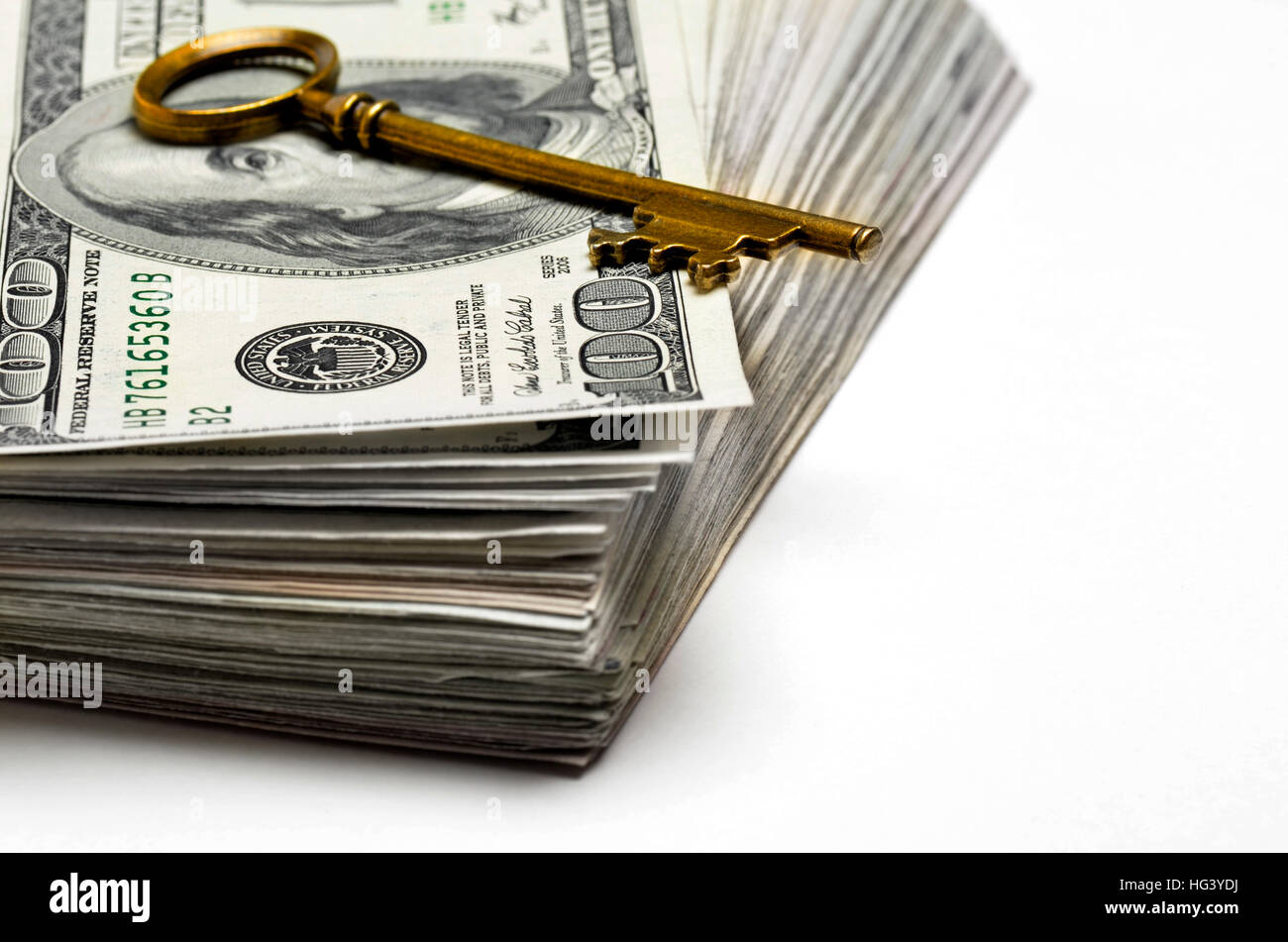 Wealth and riches represented by cash money and a key Stock Photo - Alamy