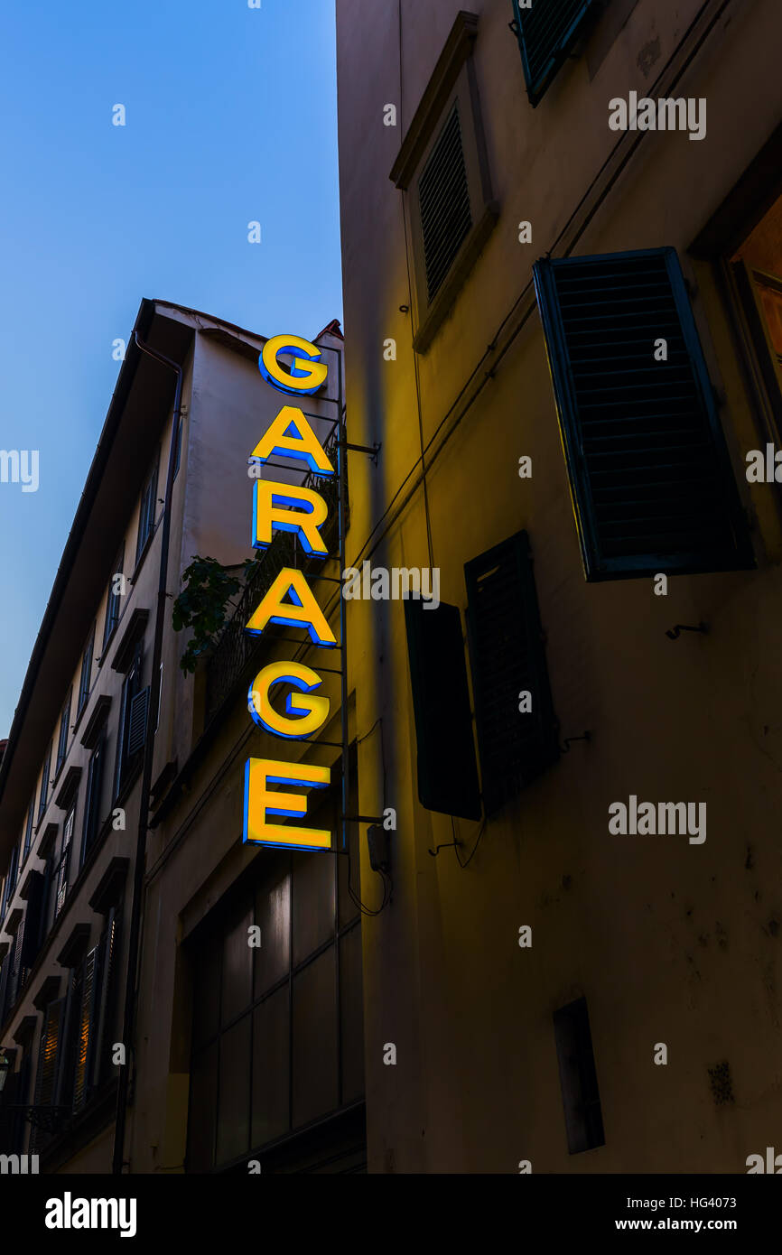 neon sign of a garage in an Italian town at night Stock Photo - Alamy