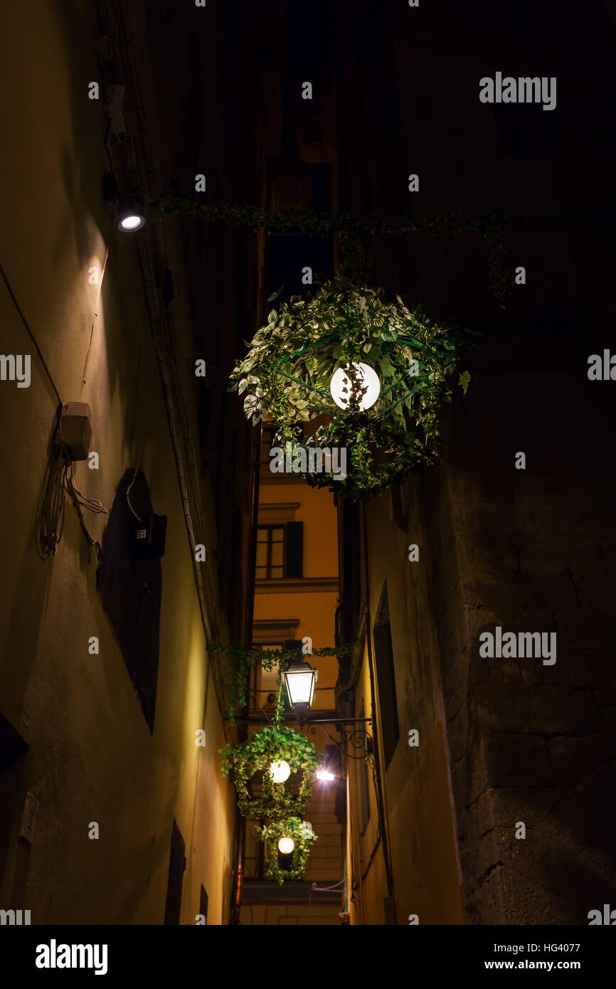 dark alley decorated street lighting in Florence, Italy Stock Photo - Alamy
