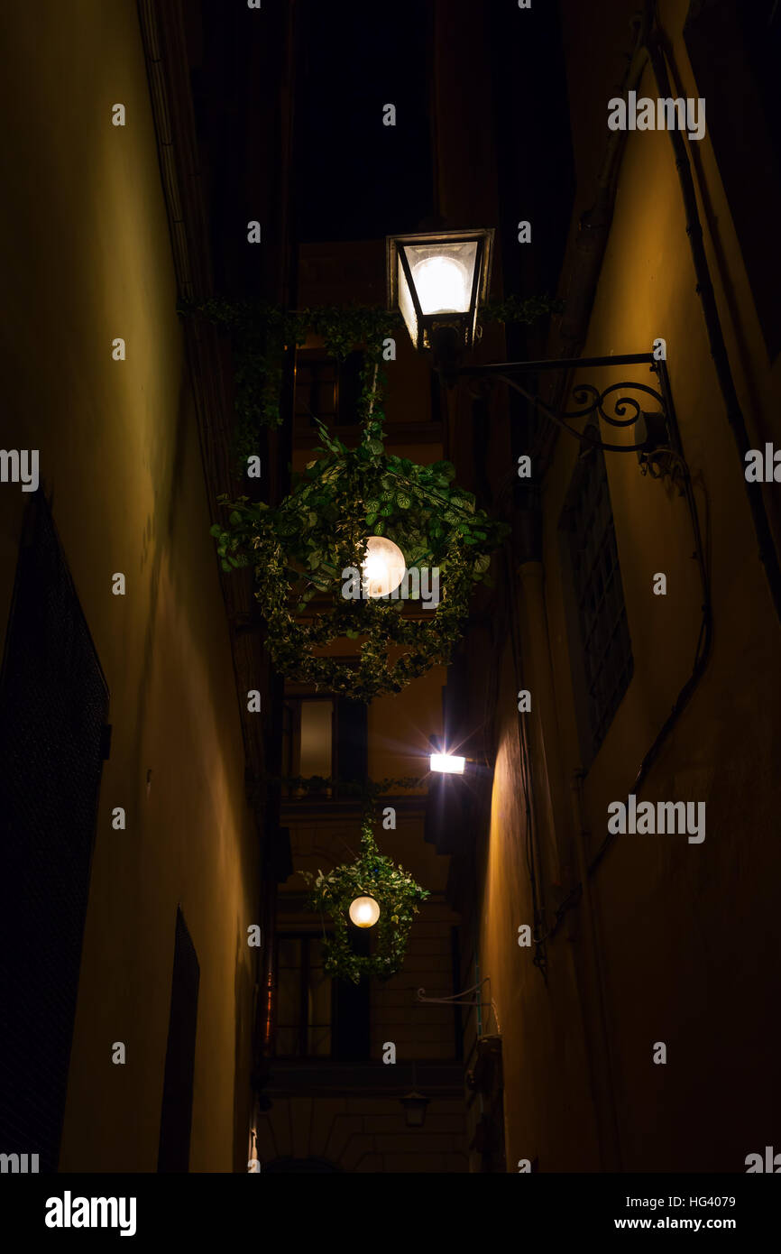 dark alley decorated street lighting in Florence, Italy Stock Photo - Alamy