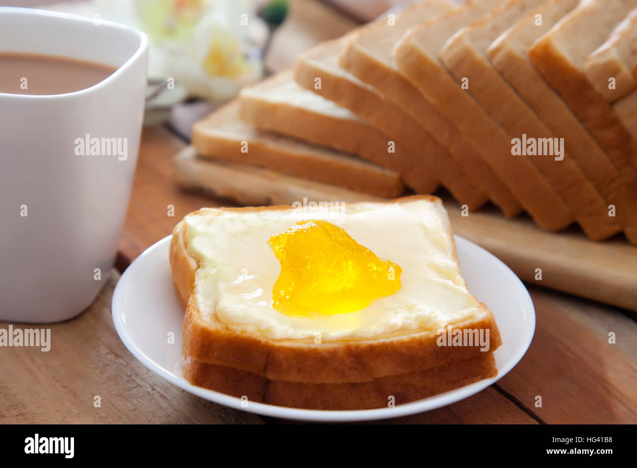 Buttered toast with pat of jam and cup of tea Stock Photo - Alamy