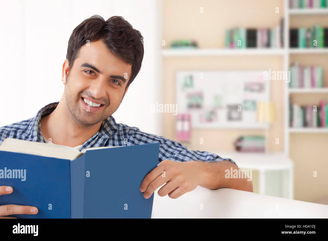 Young man reading book Stock Photo - Alamy