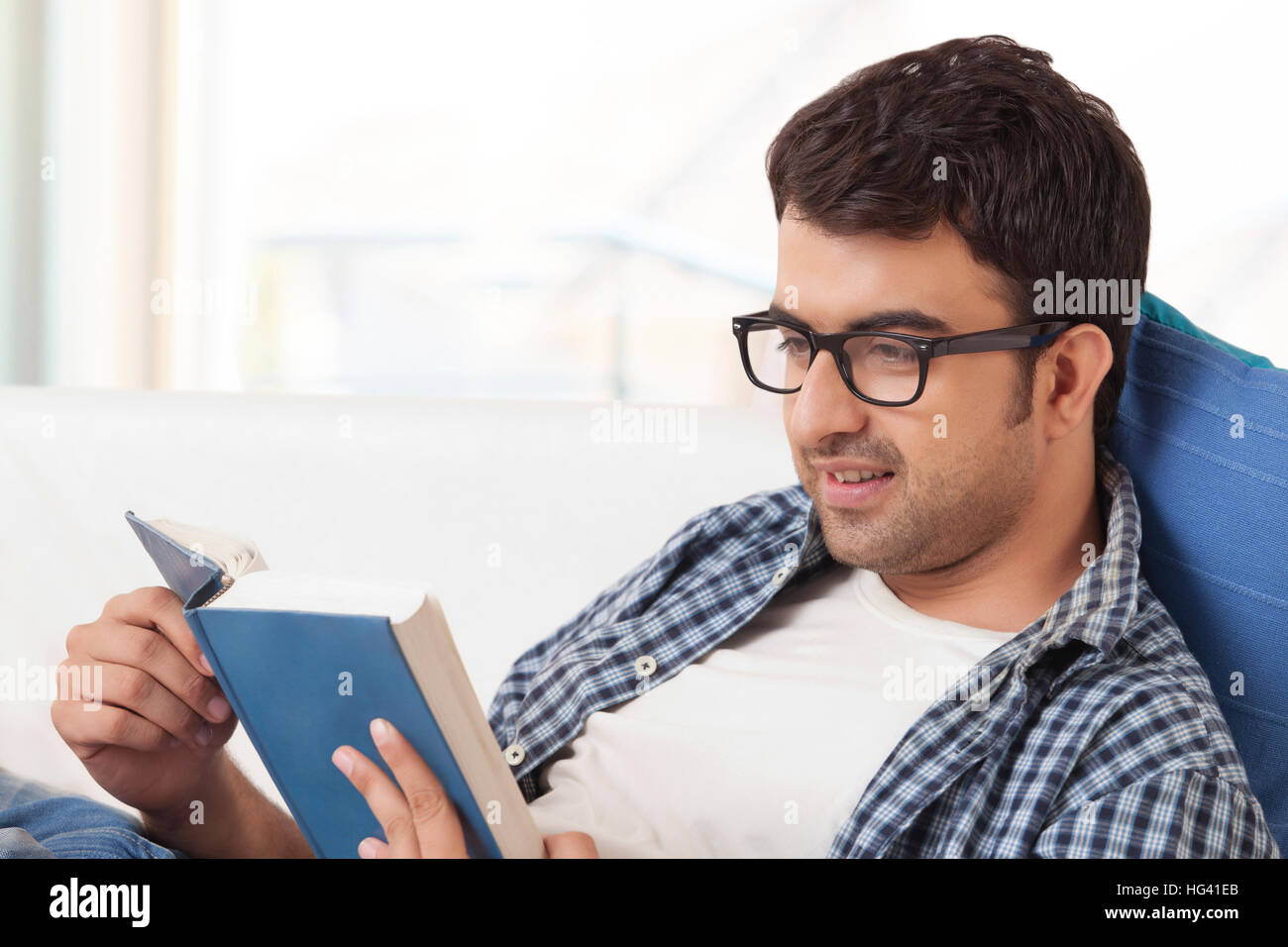 Smiling young man reading hi-res stock photography and images - Alamy