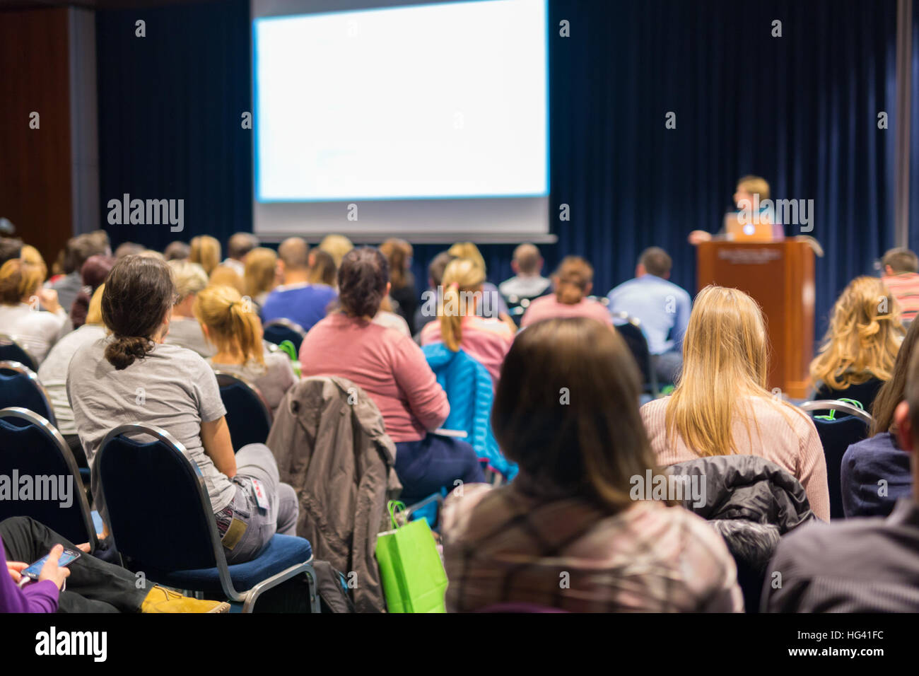 Audience in lecture hall participating at business event Stock Photo ...