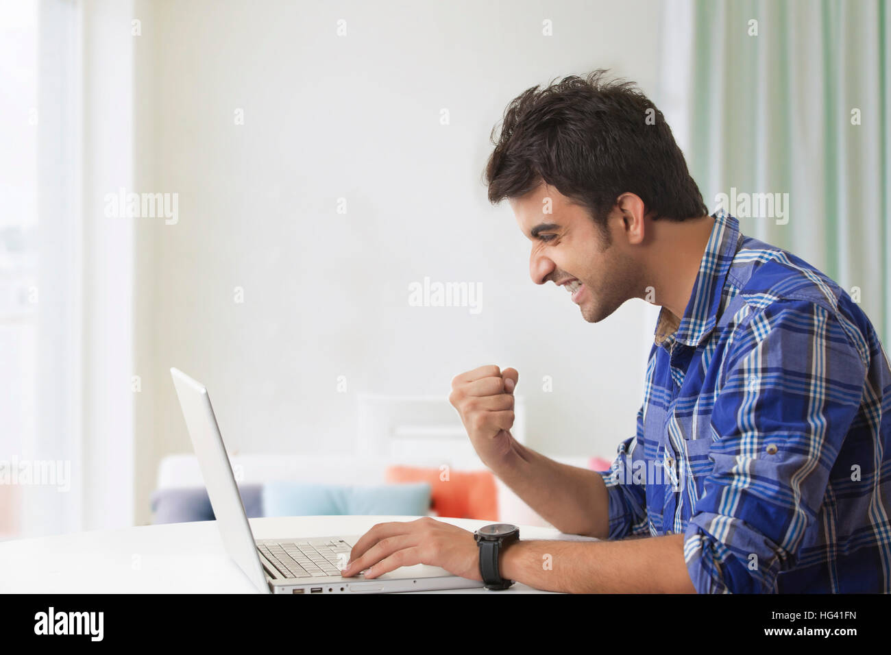 Smiling man using laptop computer Stock Photo - Alamy Smiling man using laptop computer Stock Photo - Alamy