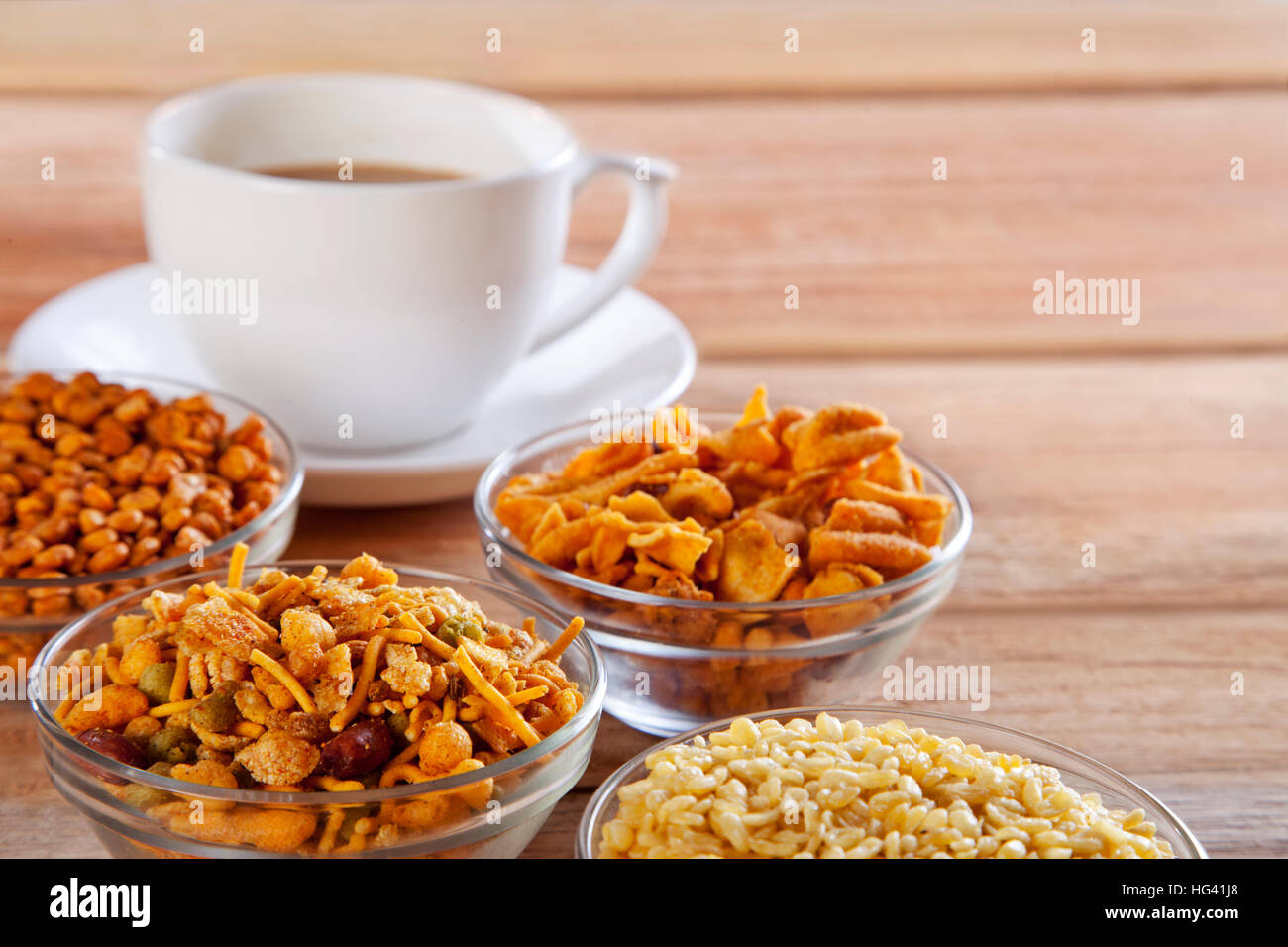 Close-up of fried snacks in bowls with cup of tea Stock Photo - Alamy
