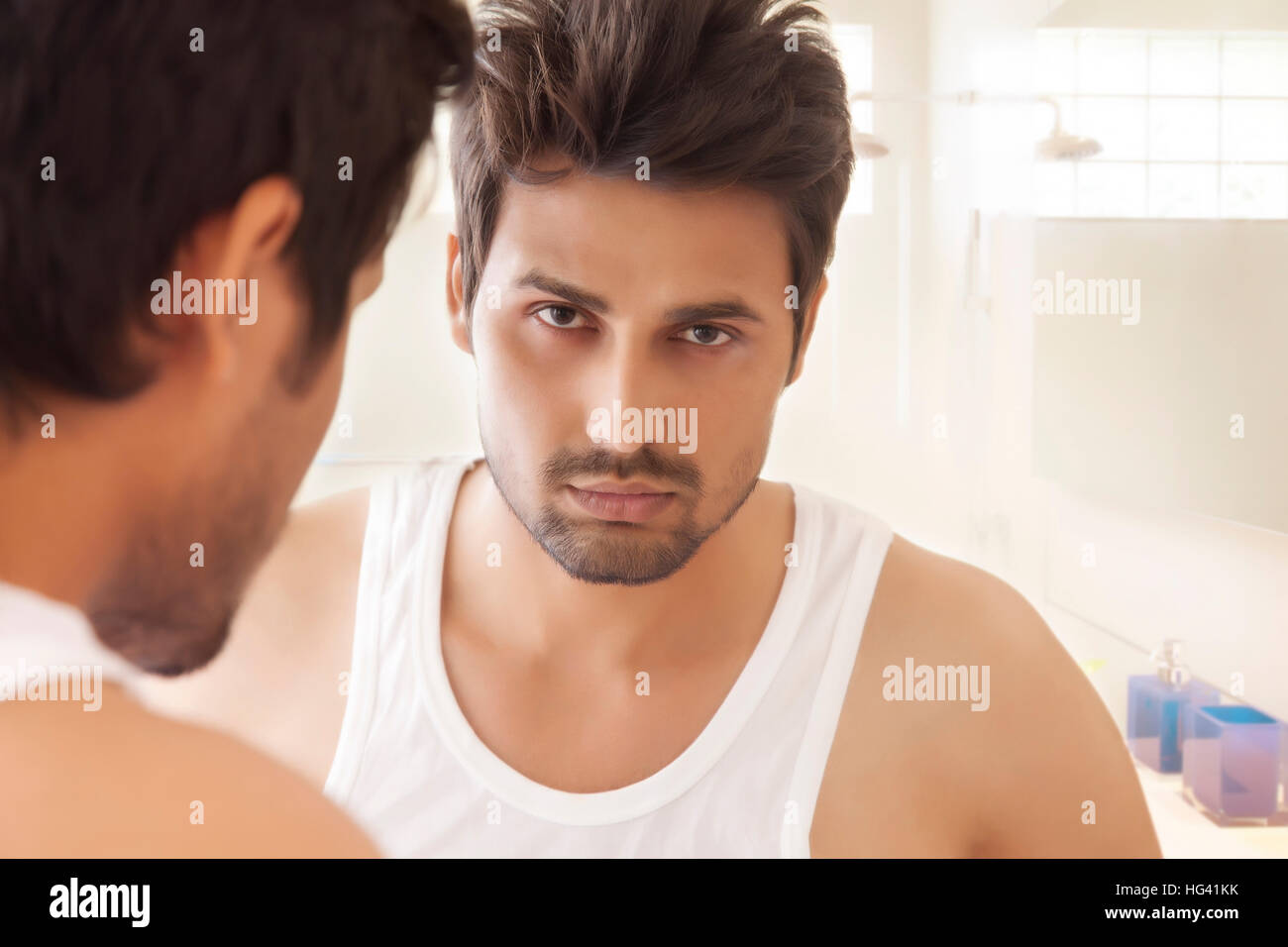 Man looking at self in mirror Stock Photo - Alamy