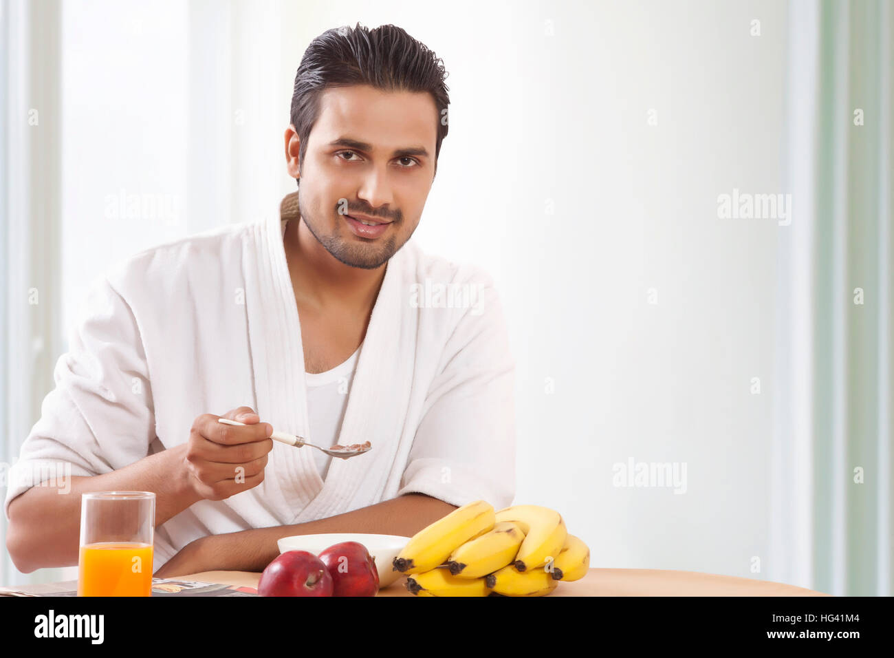 Portrait of a man having breakfast and smiling Stock Photo - Alamy