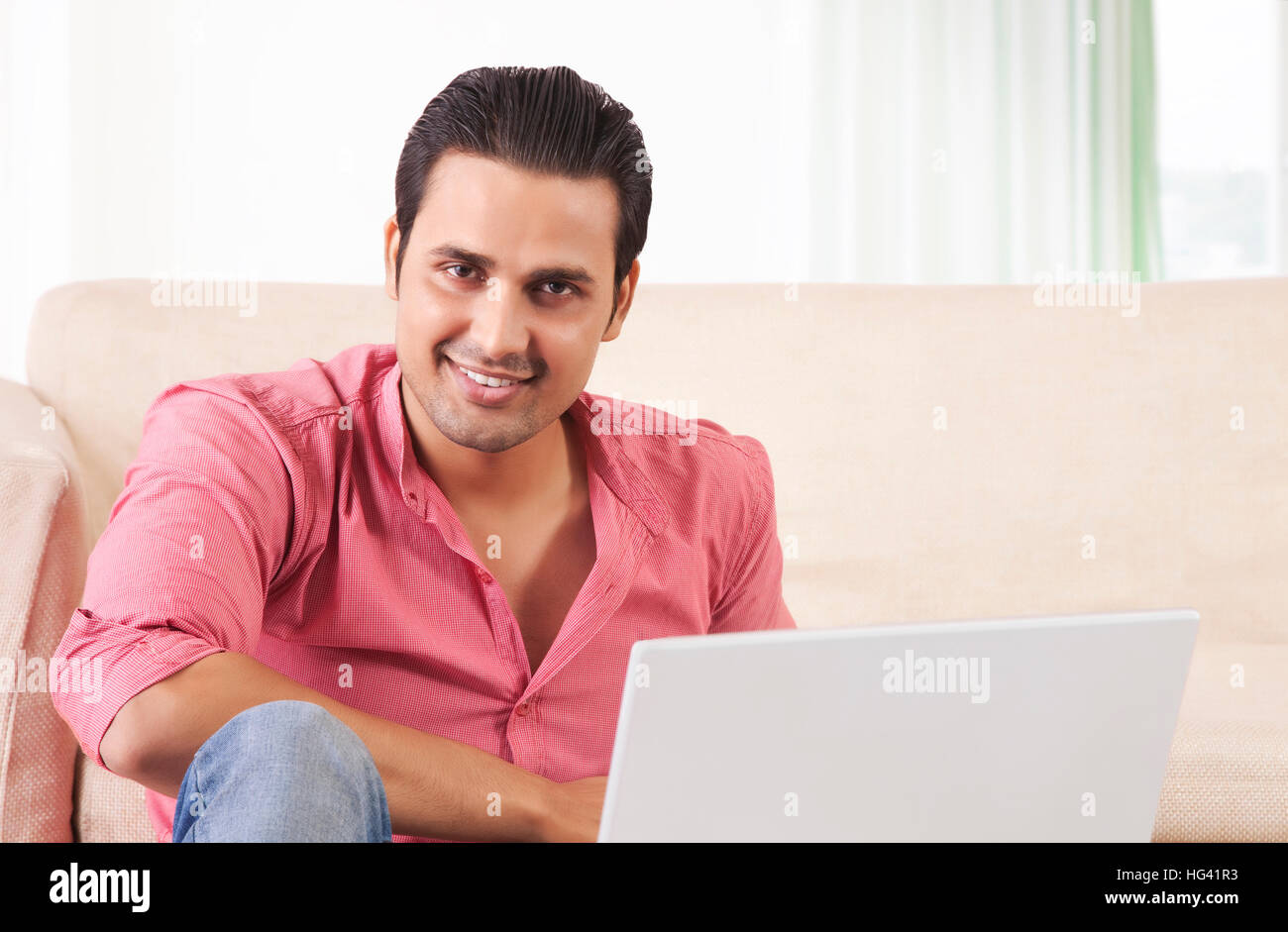 Young man using laptop Stock Photo - Alamy