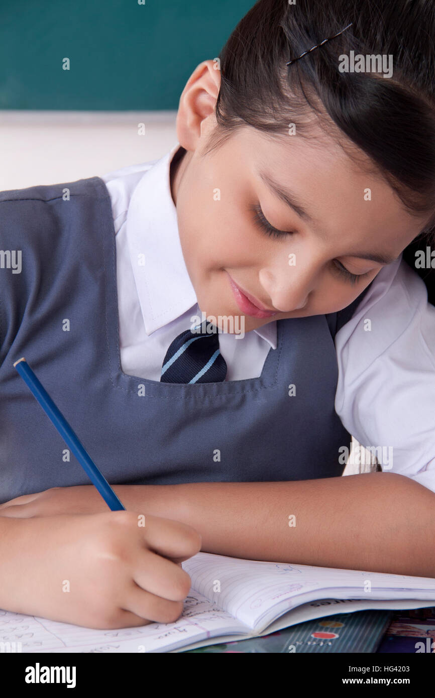 Close-Up of girl writing notes in a classroom Stock Photo - Alamy