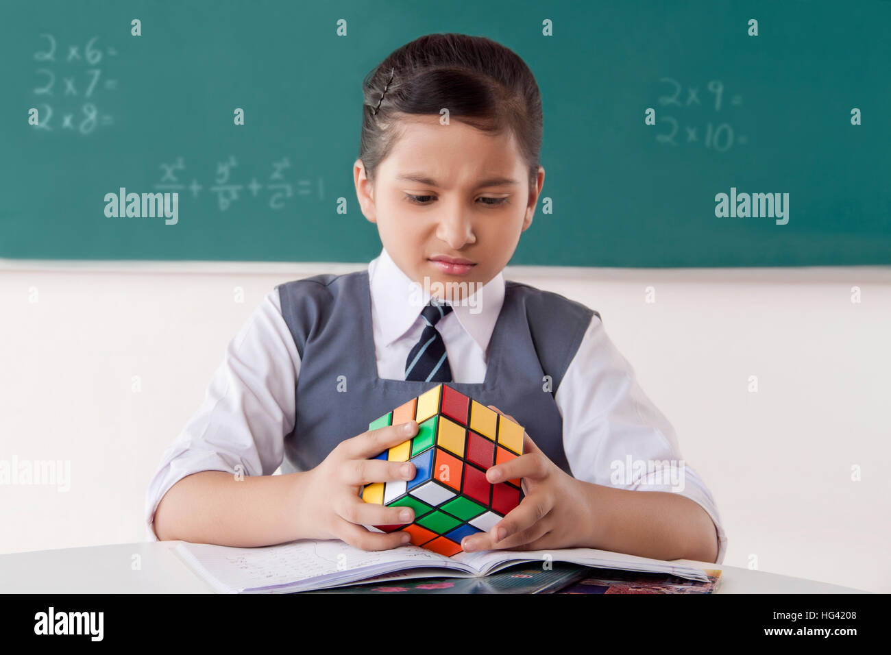 Girl with Rubik cube in a classroom Stock Photo - Alamy