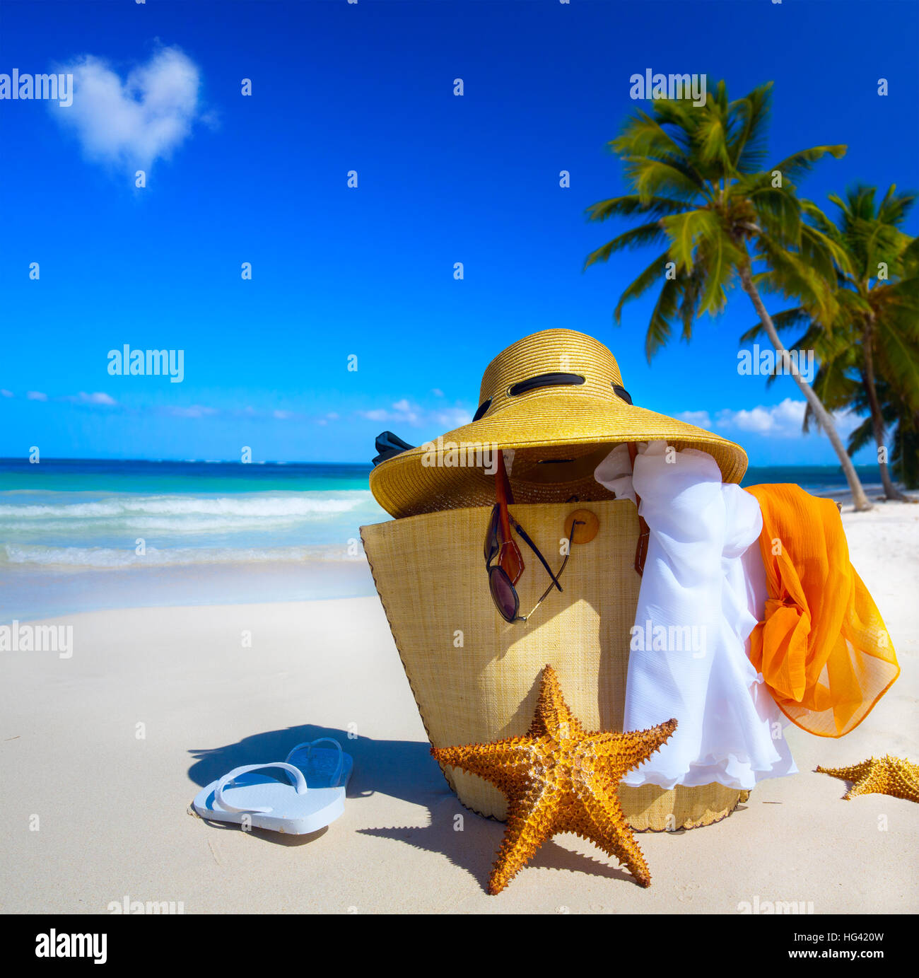 Art Straw hat, bag, sun glasses and flip flops on a tropical beach ...