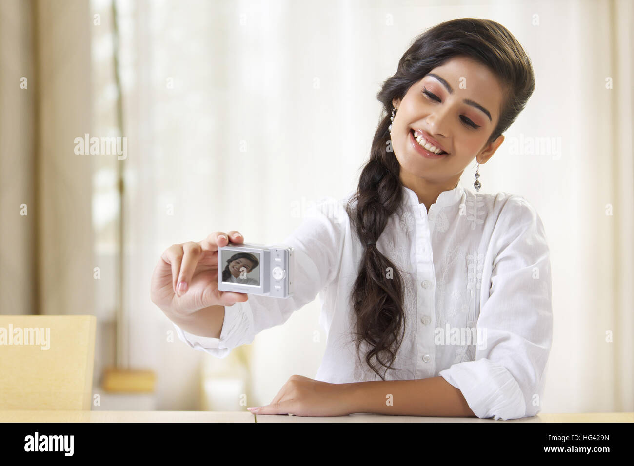Young woman taking self photo with camera Stock Photo - Alamy