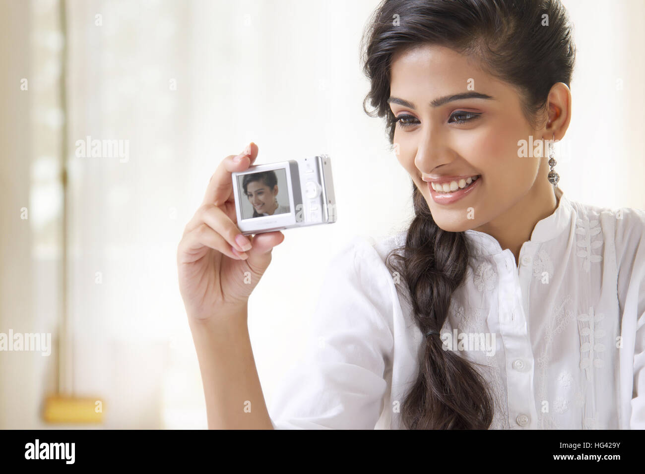 Young woman taking self photo with camera Stock Photo - Alamy