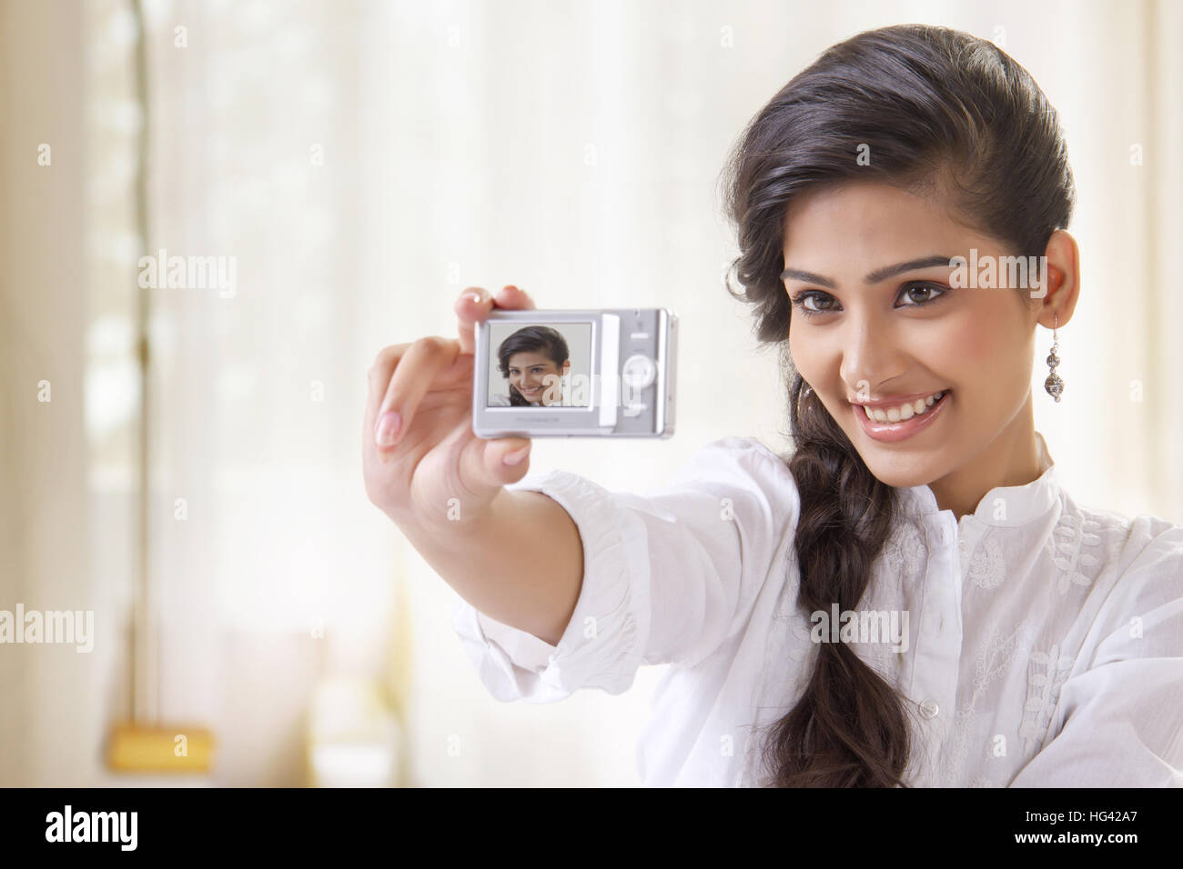 Young woman taking self photo with camera Stock Photo - Alamy