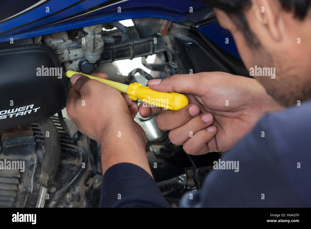 Mechanic repairing motorcycle Stock Photo - Alamy