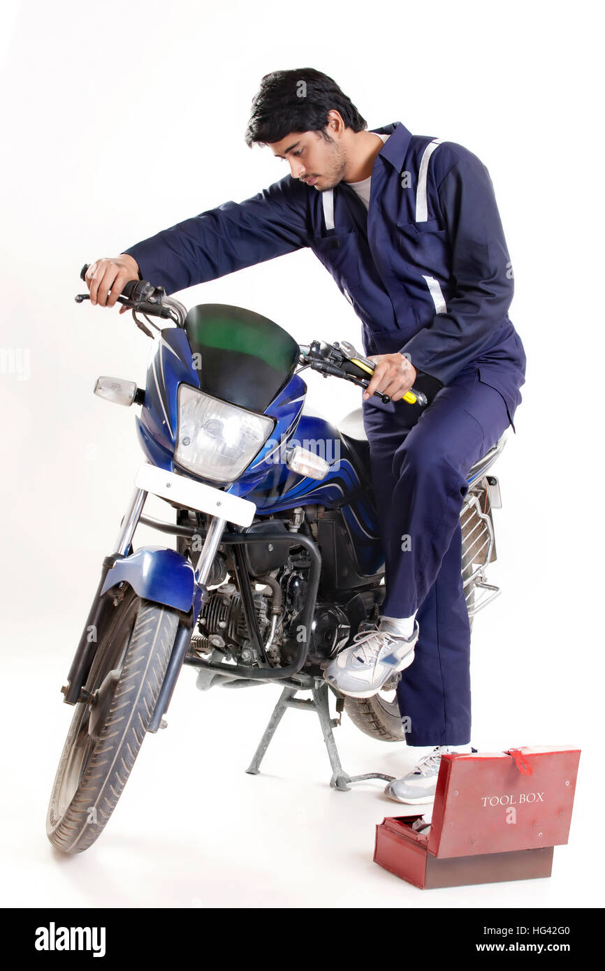 Young man working on motorbike hi-res stock photography and images - Alamy