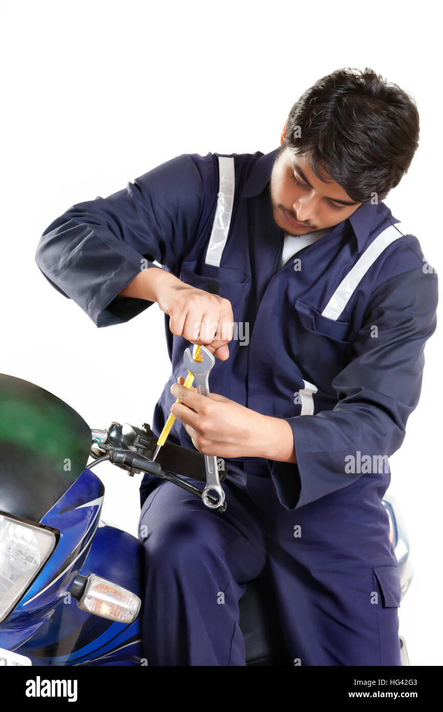 Mechanic working on motorcycle Stock Photo - Alamy