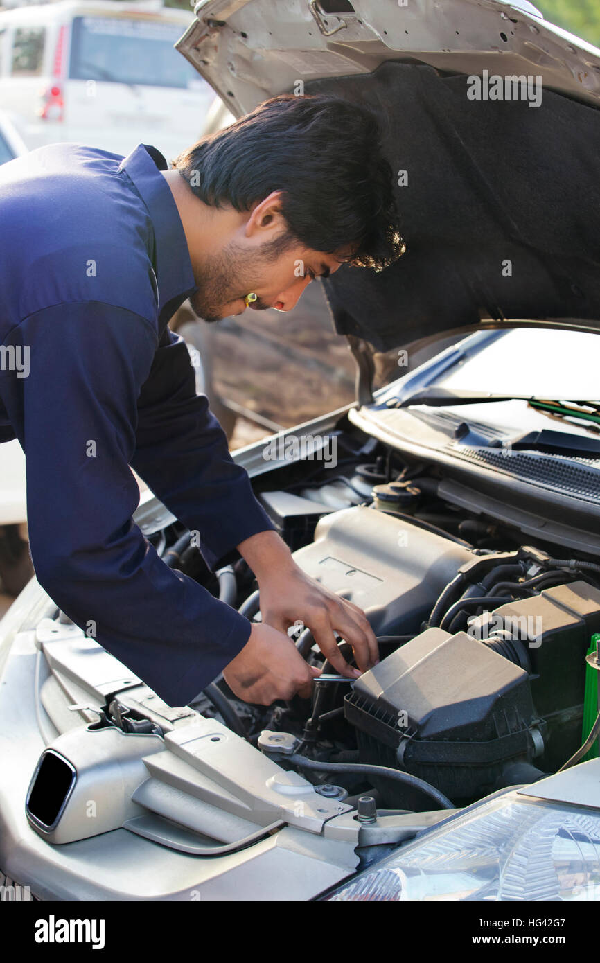 Mechanic repairing car engine Stock Photo - Alamy